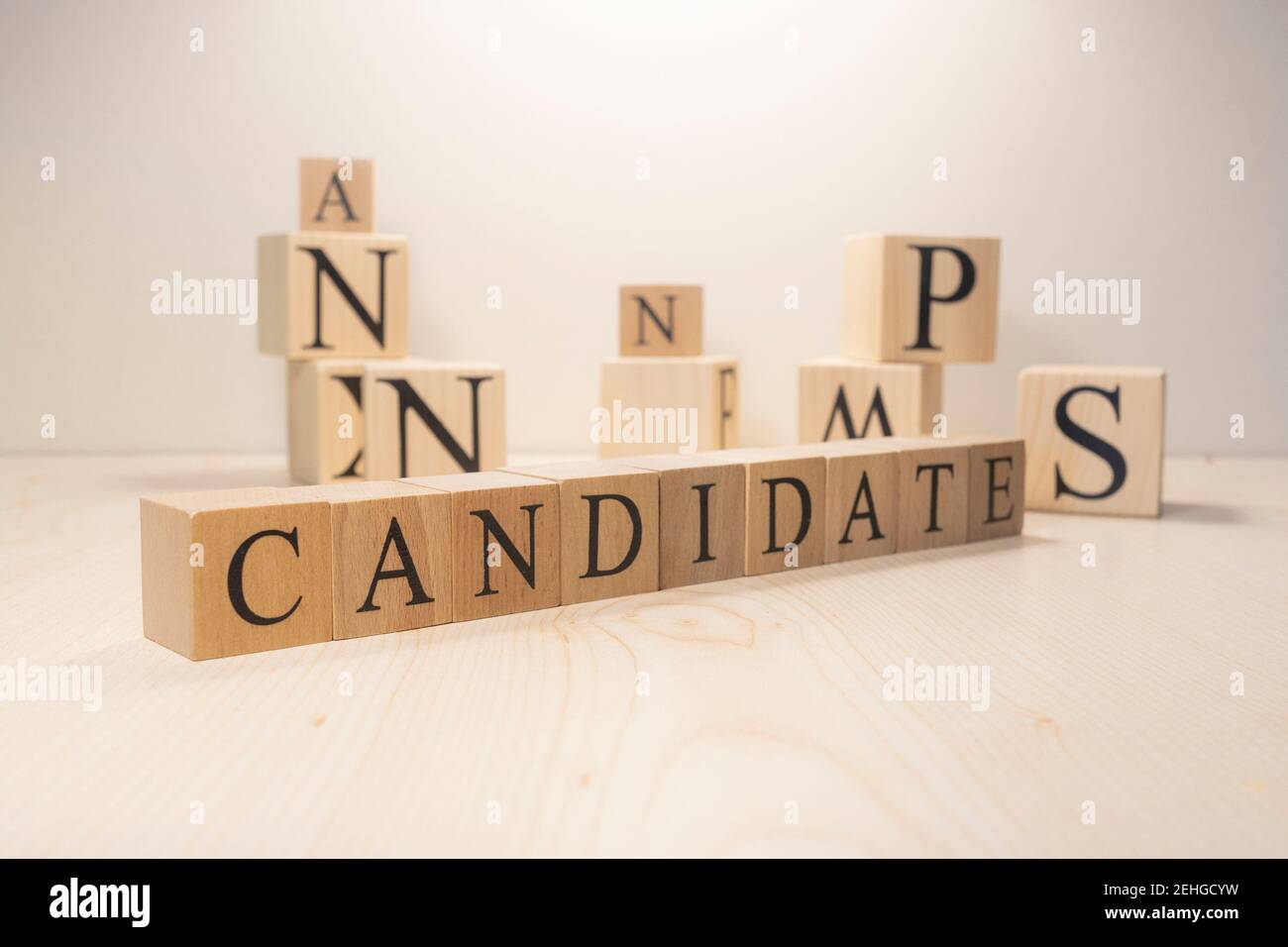 The word candidate is from wooden cubes. Background from wooden letters ...