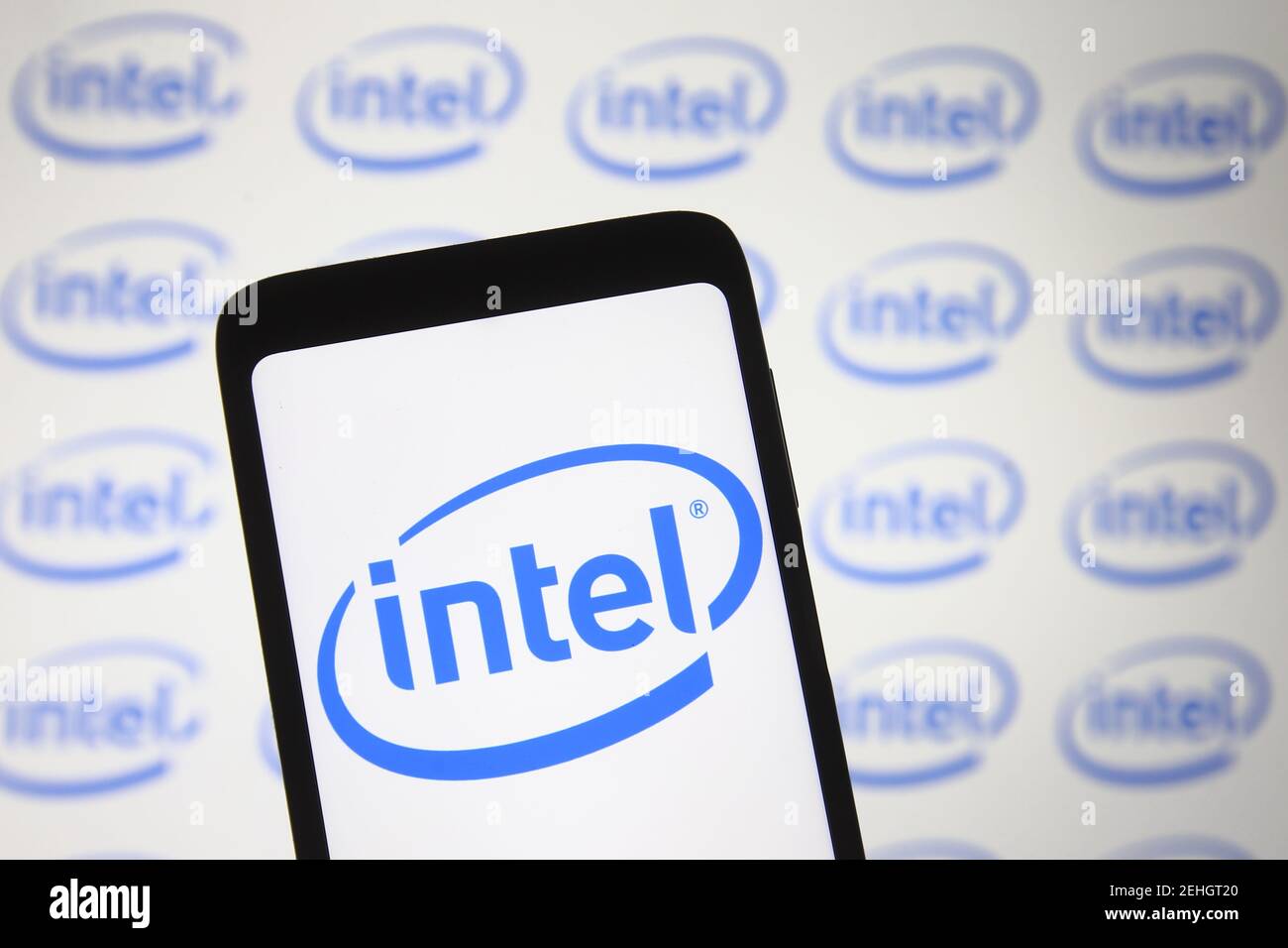 In this photo illustration an Intel logo is seen on a smartphone and a ...