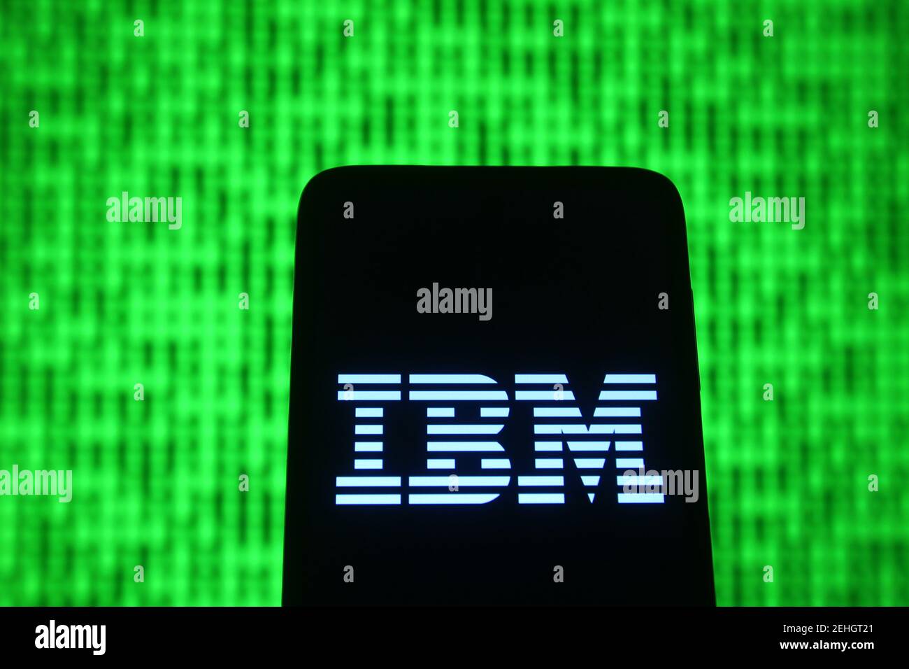 In this photo illustration an IBM logo is seen on a smartphone screen ...