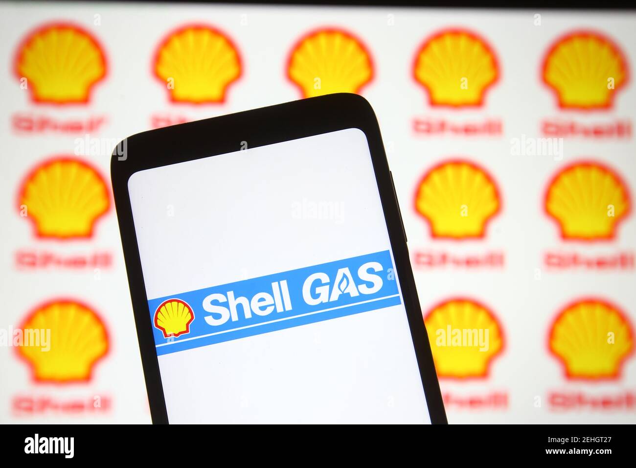 In this photo illustration a Shell gas logo is seen on a smartphone and ...
