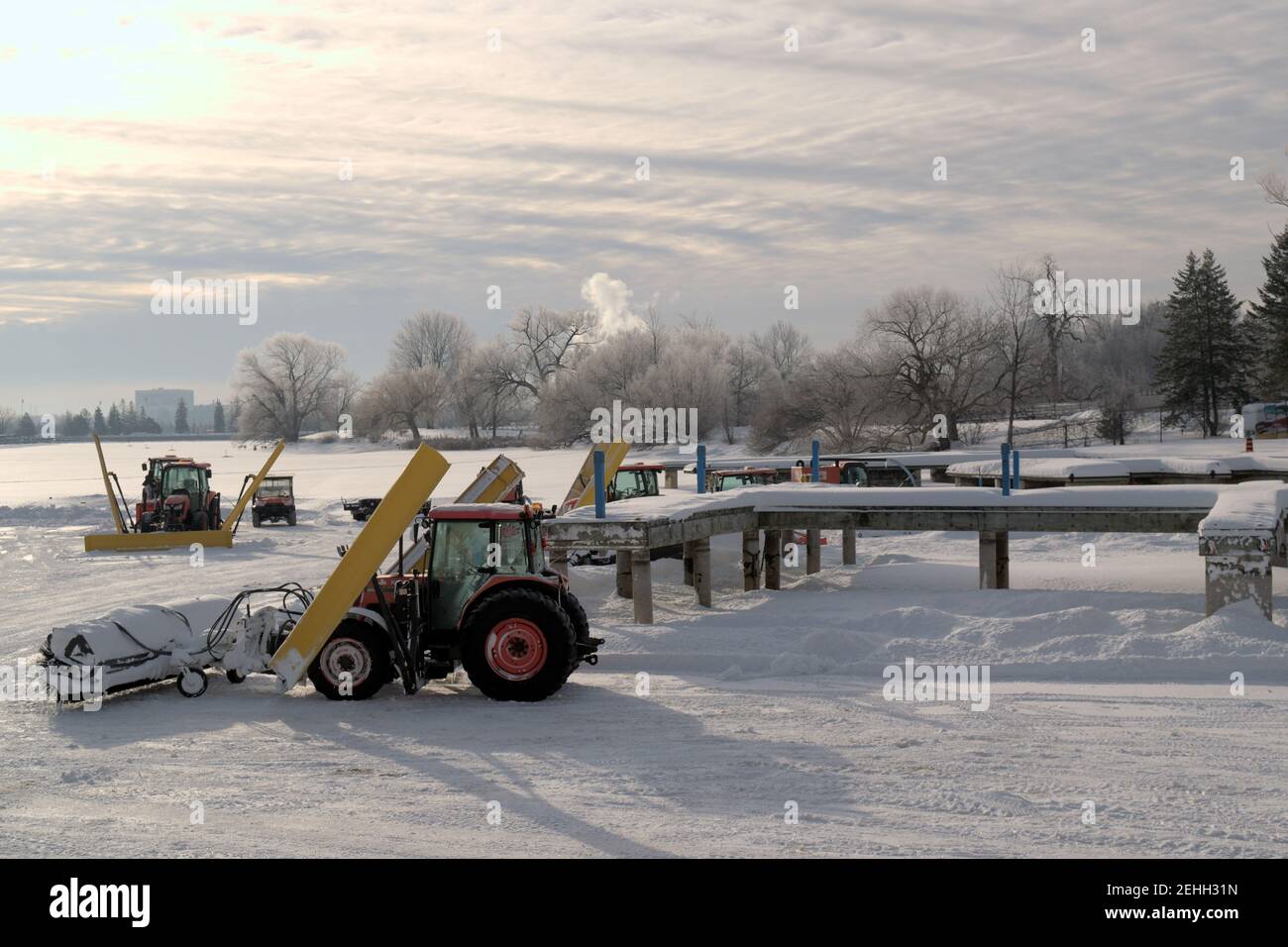 Snow plow tractors parked on Dow's Lake. These maintain the skating ...