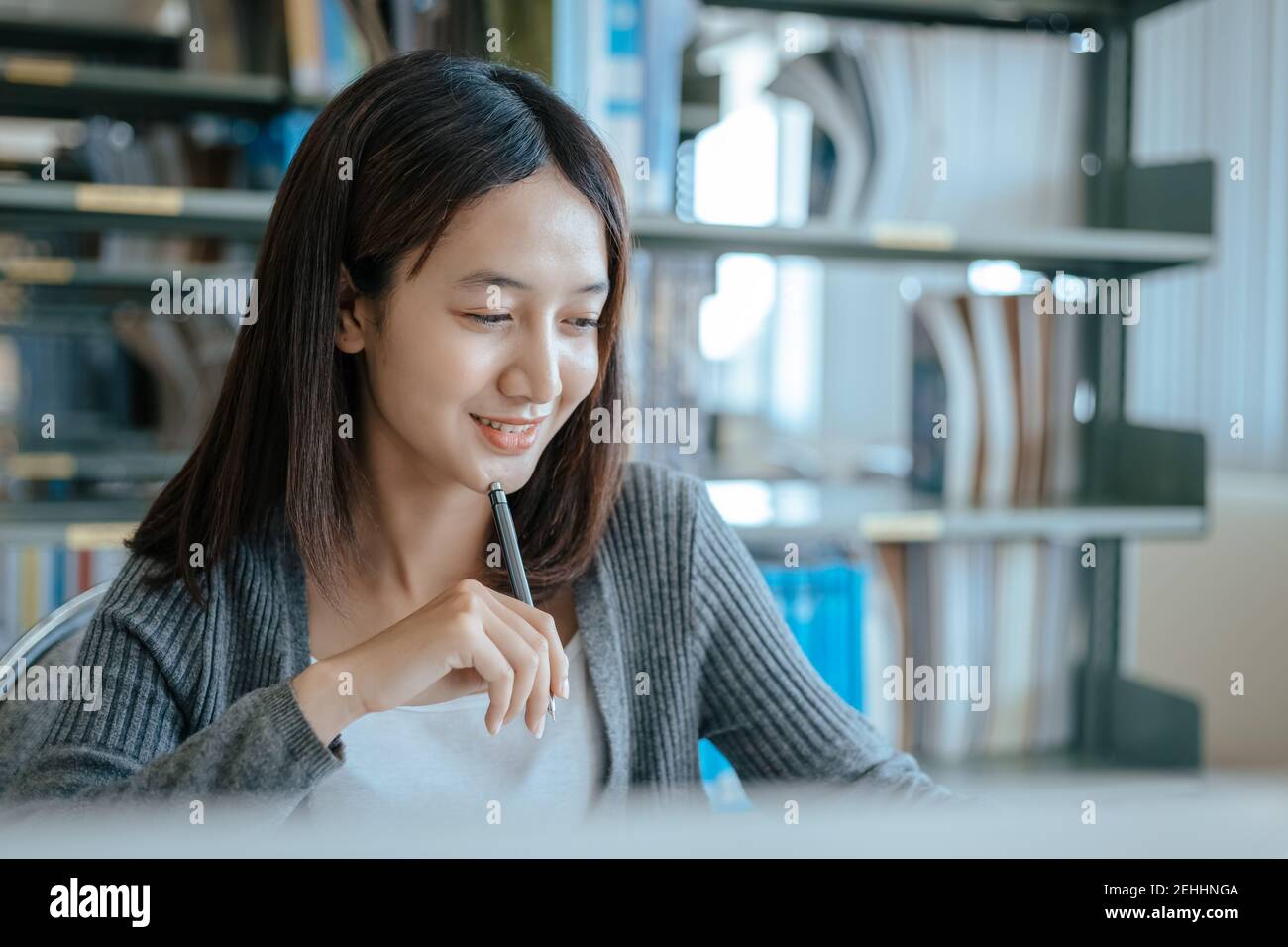 Student open a book and read for exam in the library. Education concept ...