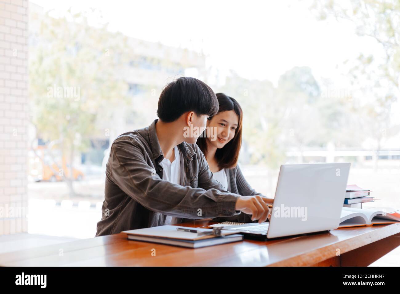 High school or college students group catching up workbook and learning ...