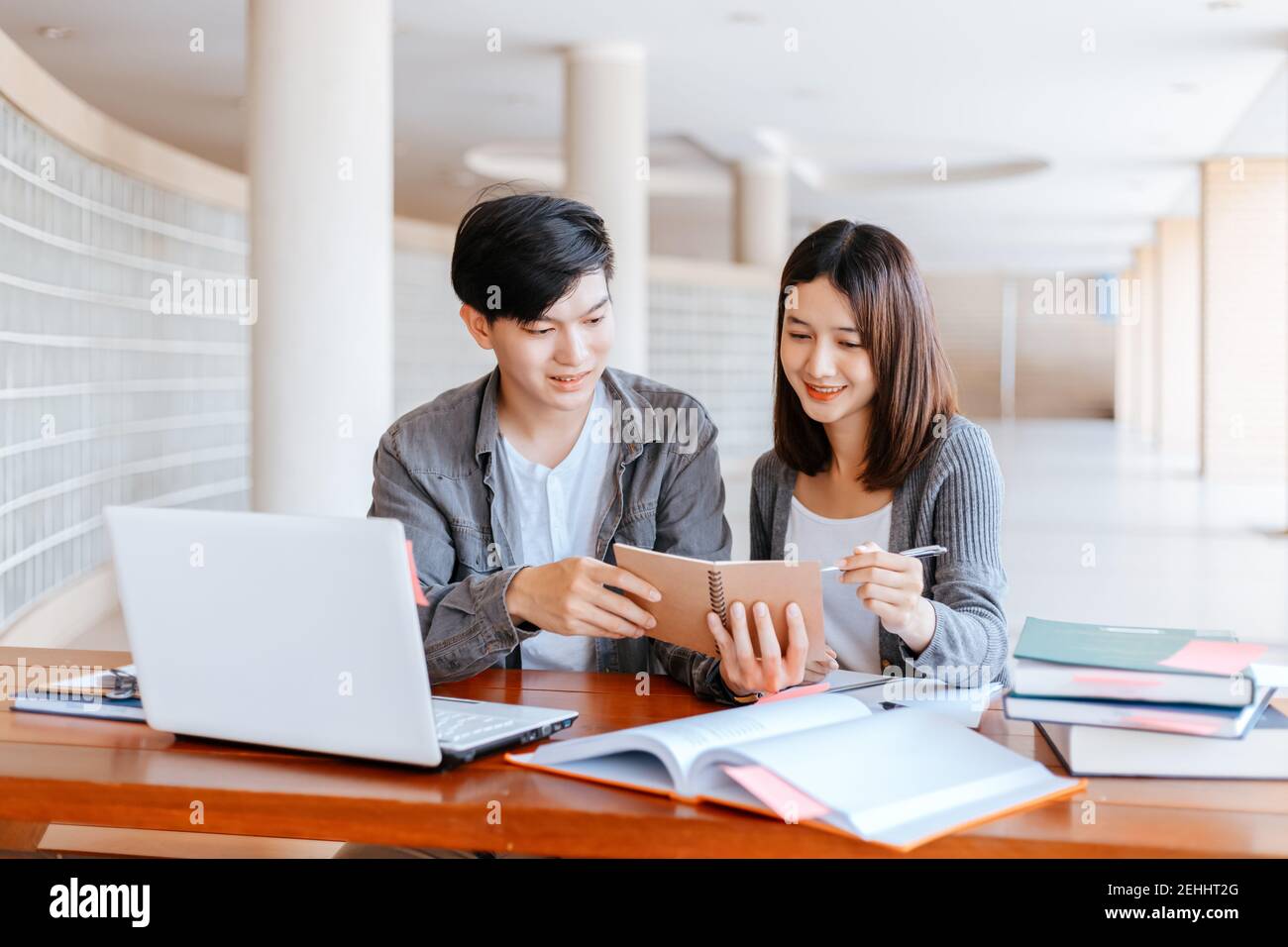 High school or college students group catching up workbook and learning ...