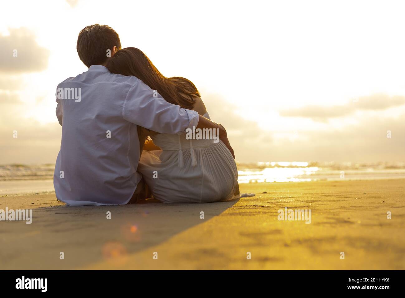 Couple in love watching sunset together on the beach travel summer ...