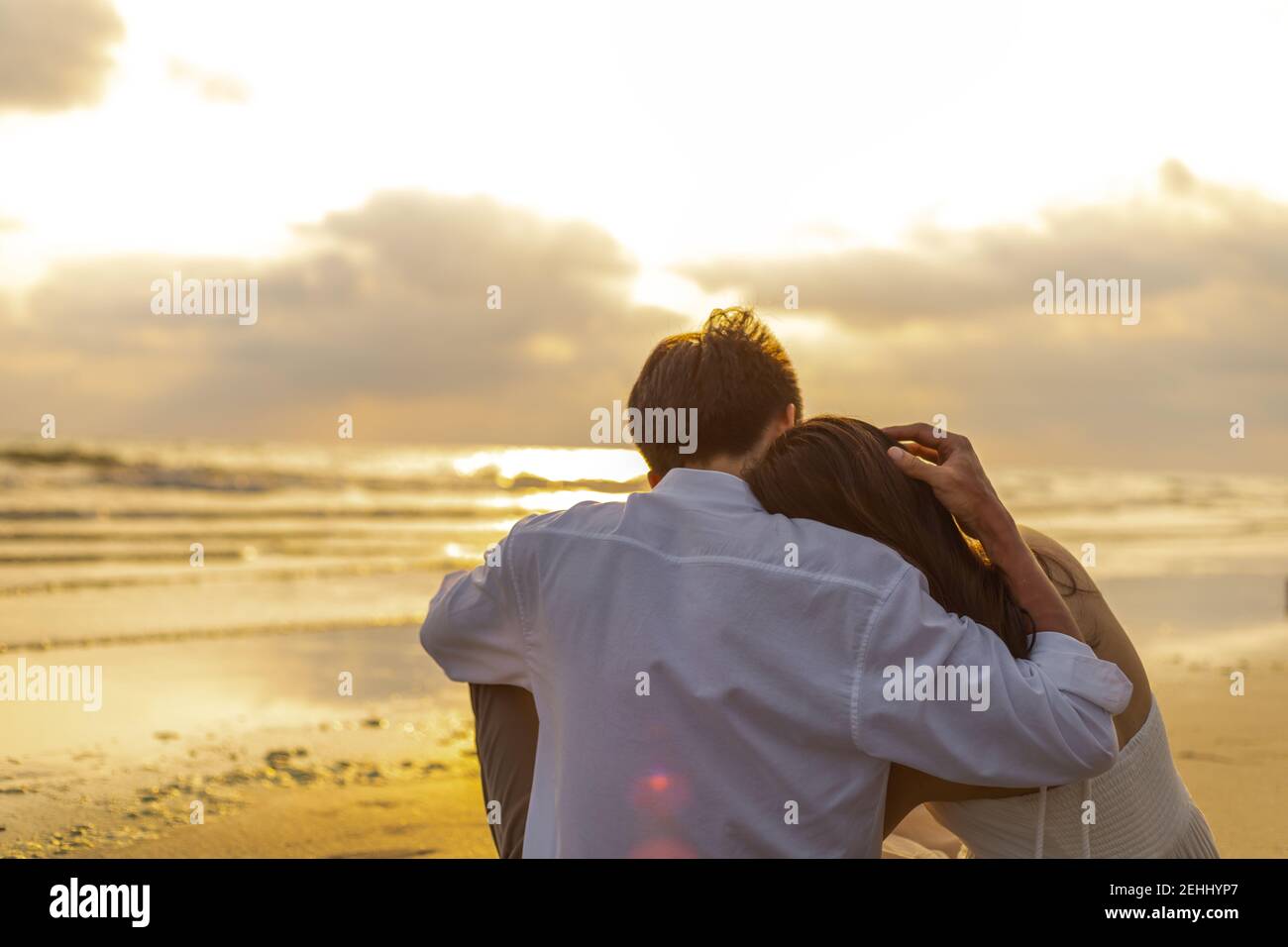 Couple in love watching sunset together on the beach travel summer ...