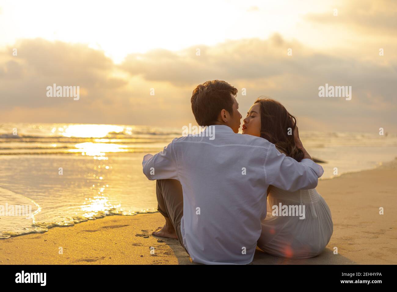 Couple in love watching sunset together on the beach travel summer ...