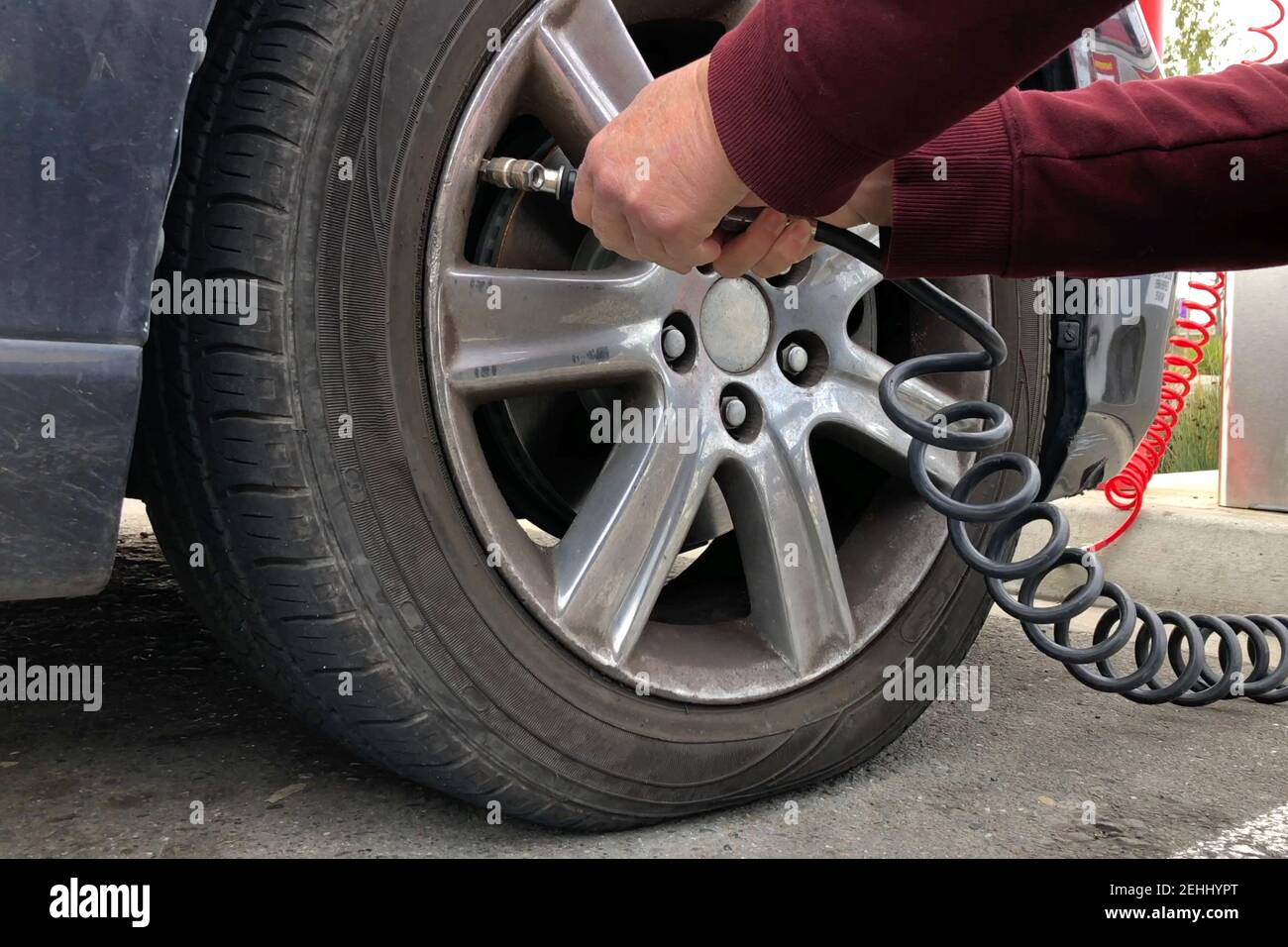 Close up of an older woman, female hands using automated air pump to ...