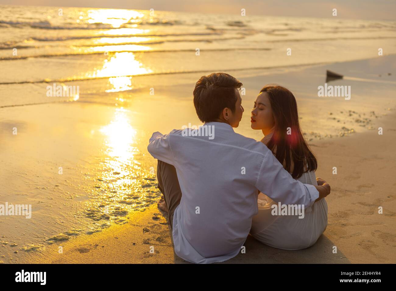 Couple in love watching sunset together on the beach travel summer ...