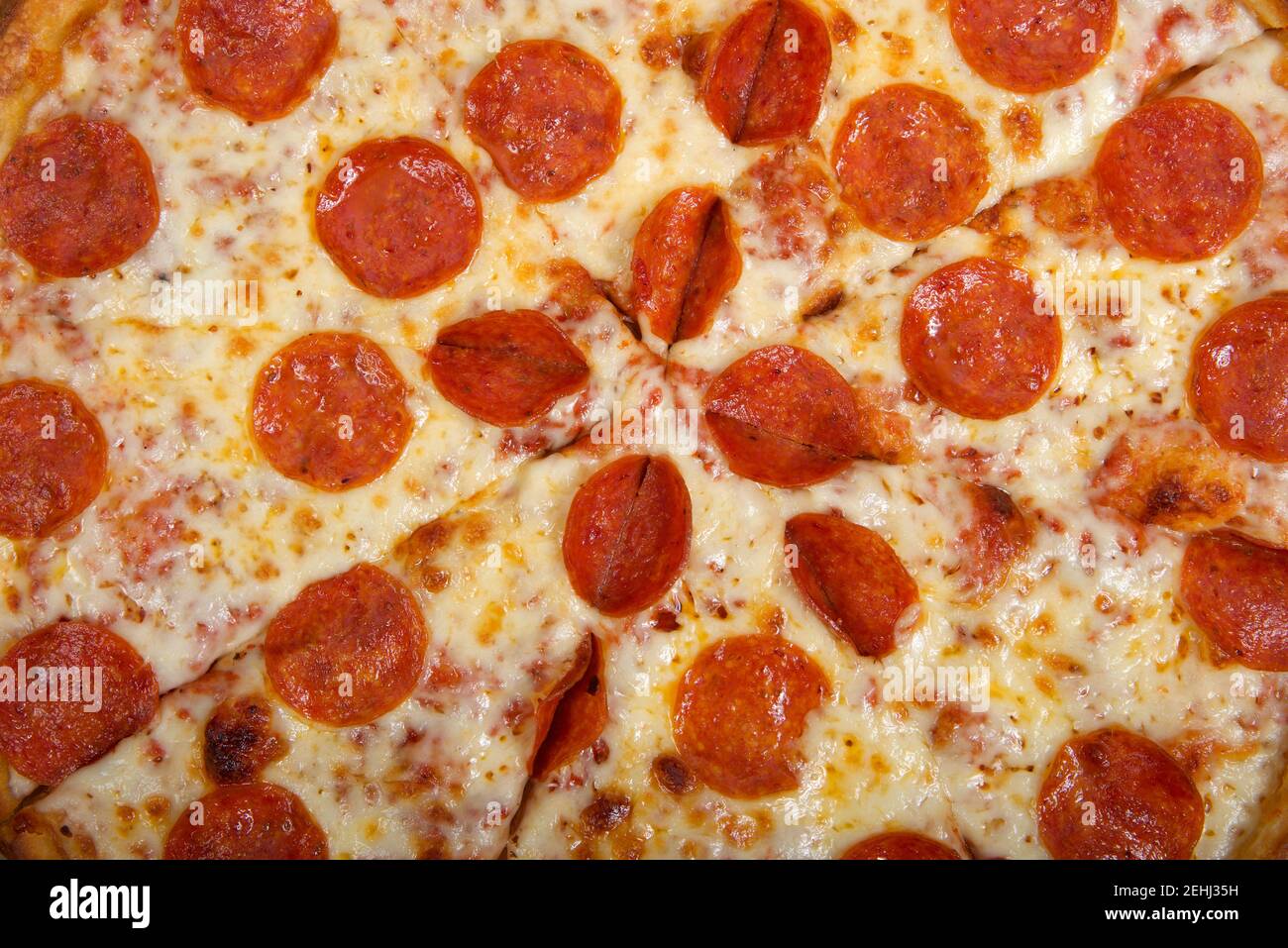 Top view flat lay of one whole sliced pepperoni pizza in the box. Close ...