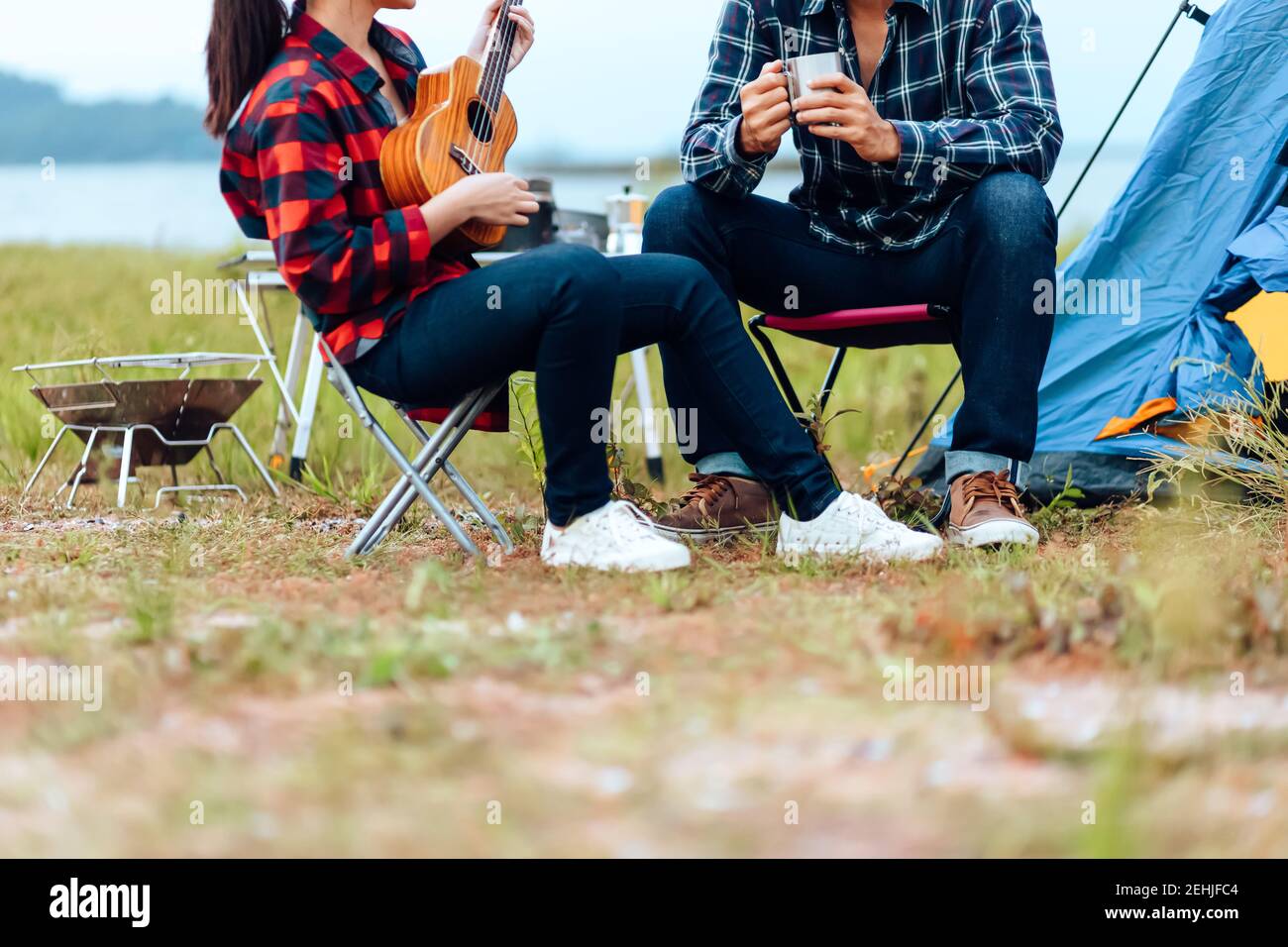 Group of friends camping and they are sitting playing guitar. Camp and ...