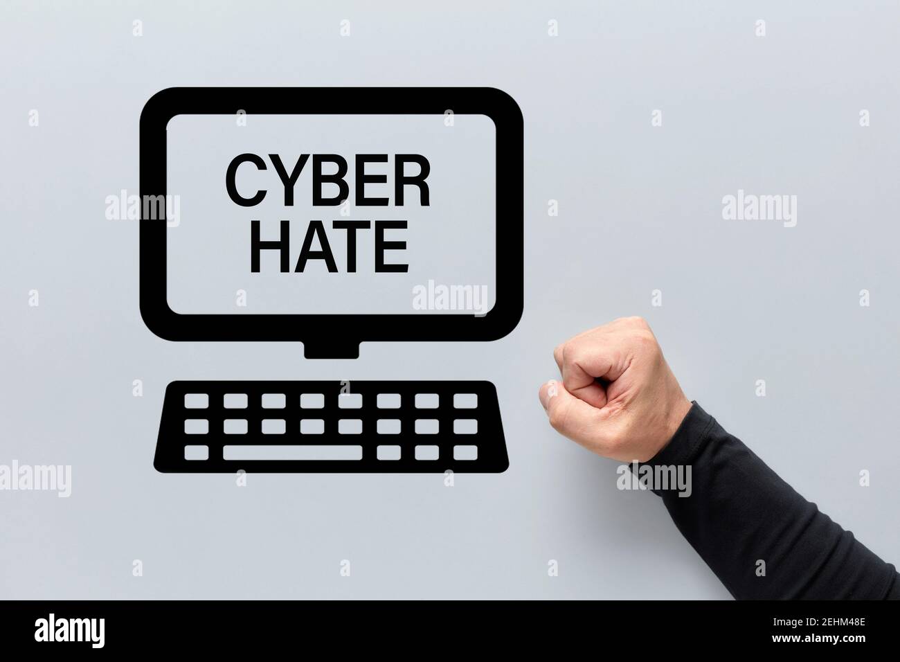 Male fist with a computer icon with cyber hate written on the screen ...