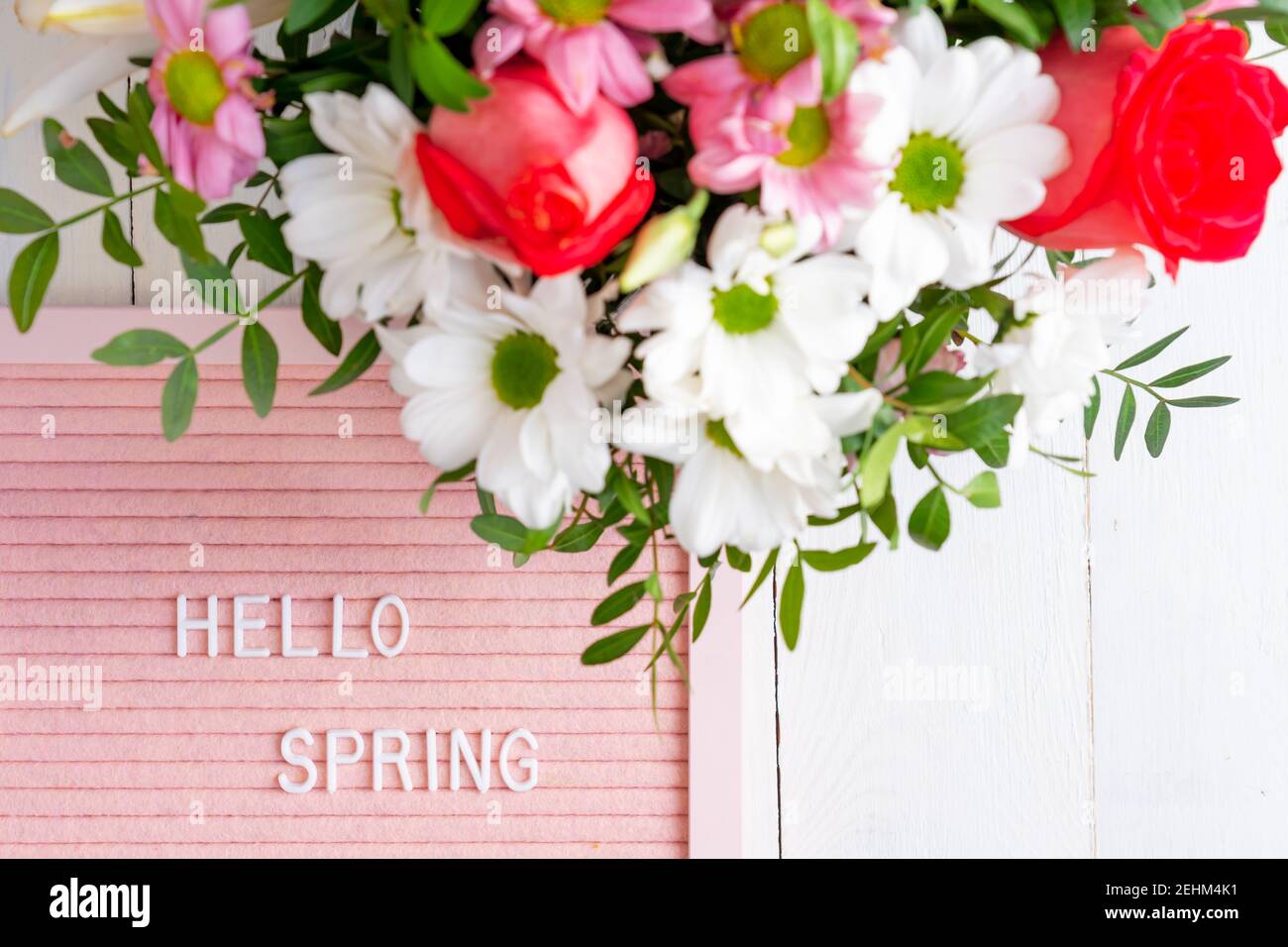 Quote - Hello spring. Border frame made of blooming flowers on a white ...