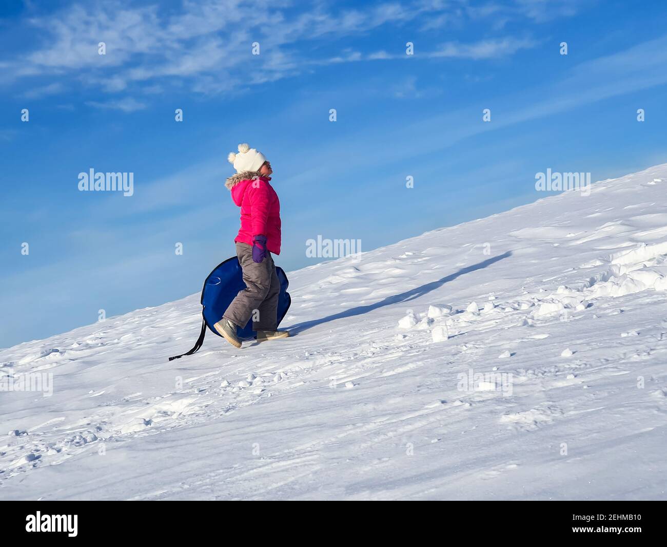 A child is tubing on a snow slide Stock Photo - Alamy