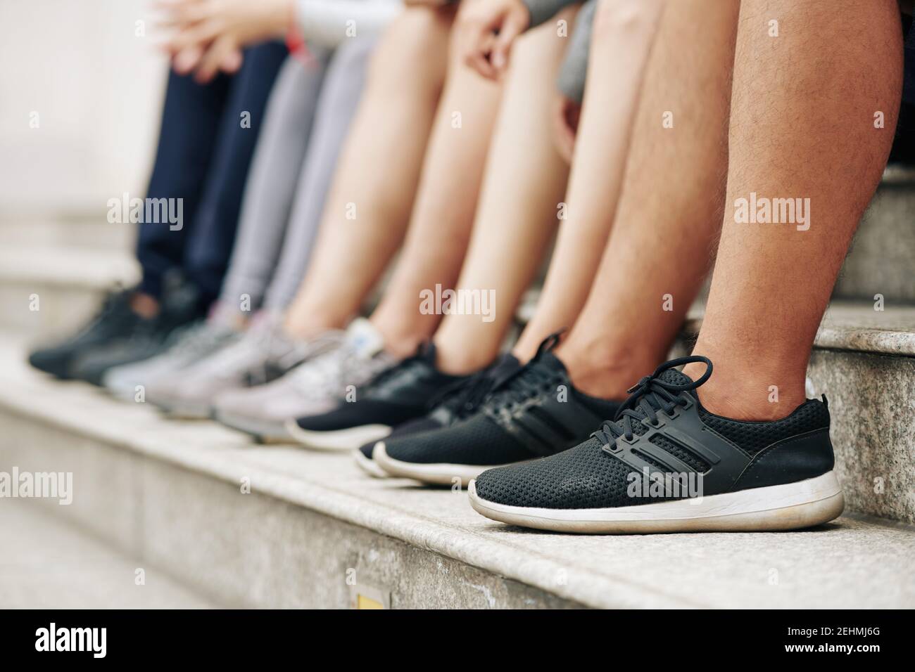 Sportsmen resting on steps Stock Photo - Alamy