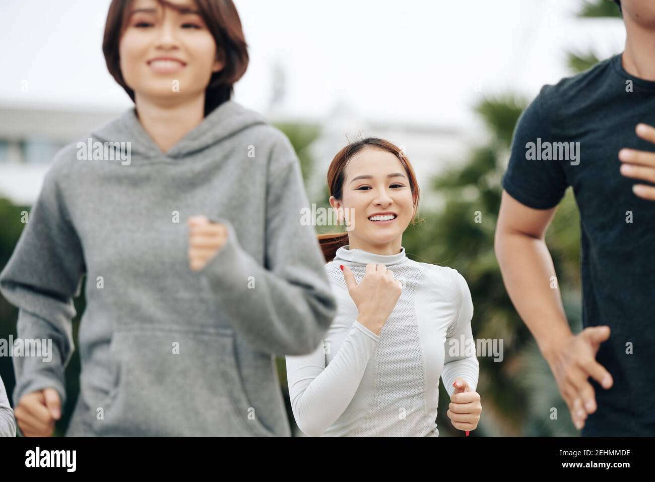 Cheerful friends group running marathon hi-res stock photography and ...