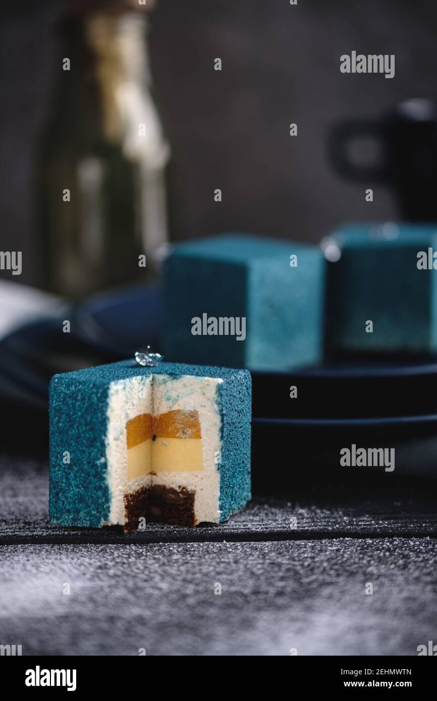 Blue cake filled with orange and tangerine in the shape of a cube ...
