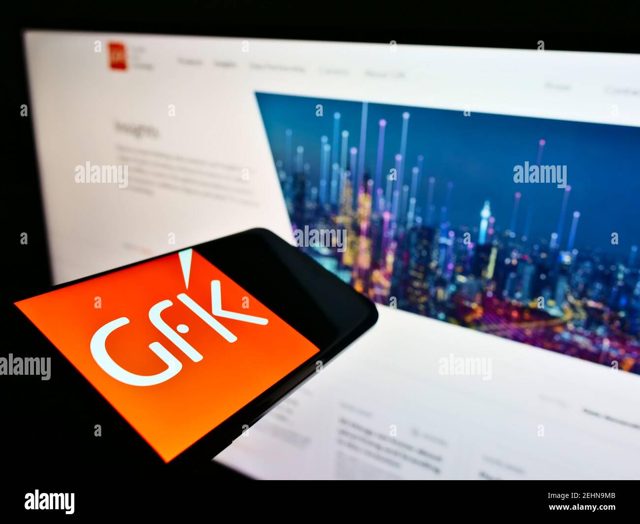 Cellphone with business logo of German market research institute GfK SE ...