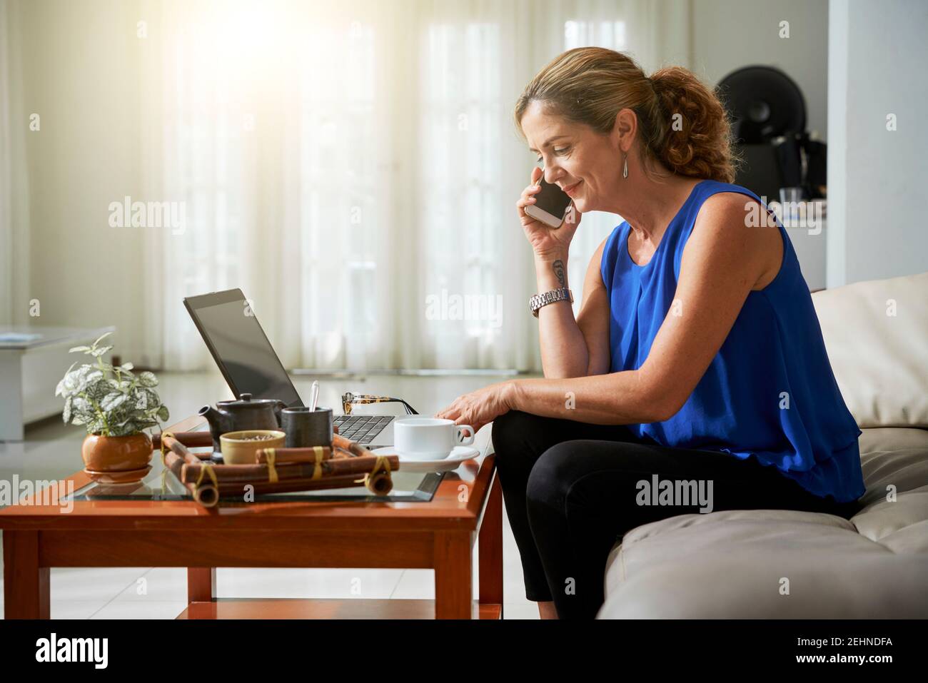 Mature woman making phone call Stock Photo - Alamy