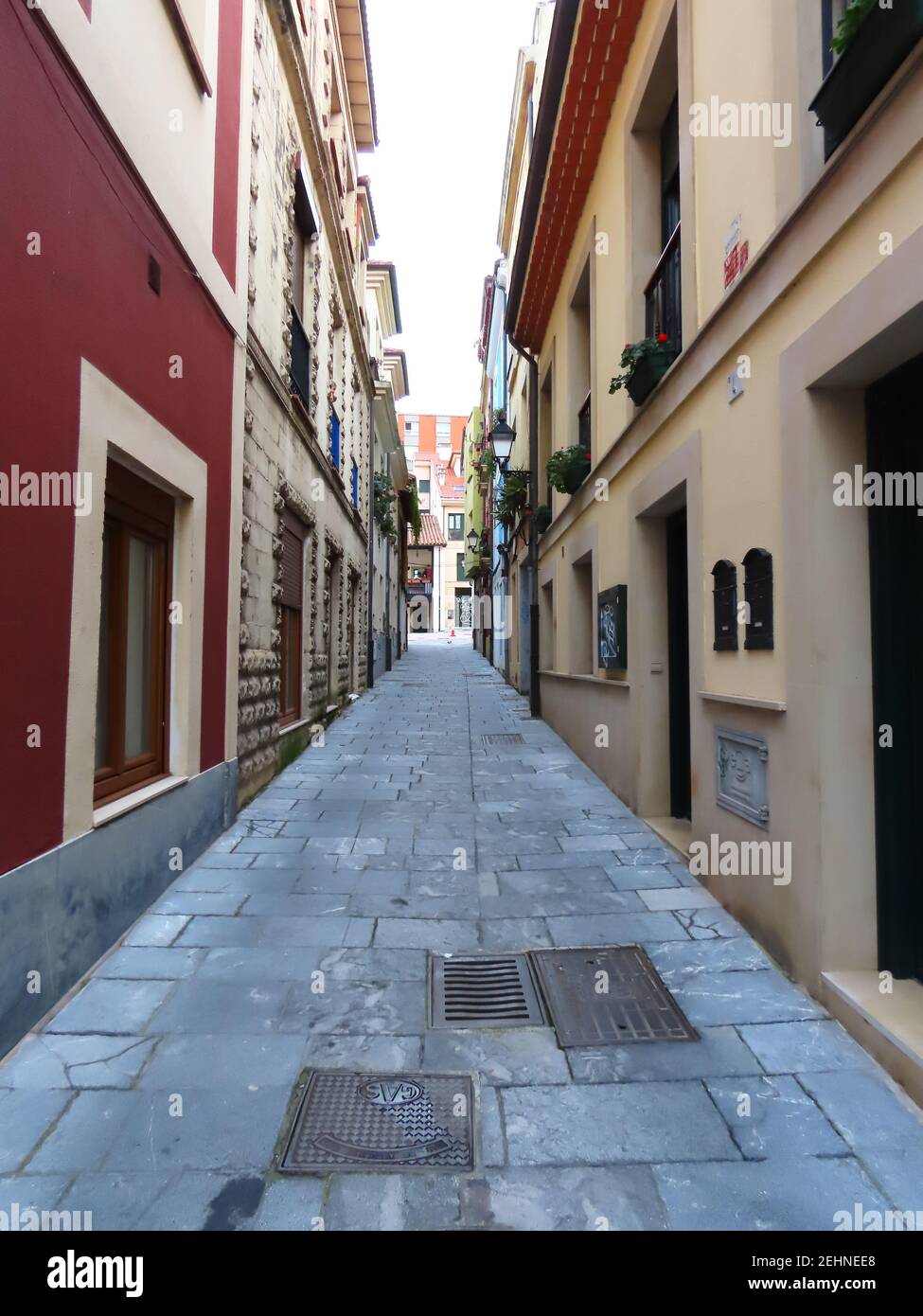Vertical shot of a narrow path between two urban building Stock Photo ...