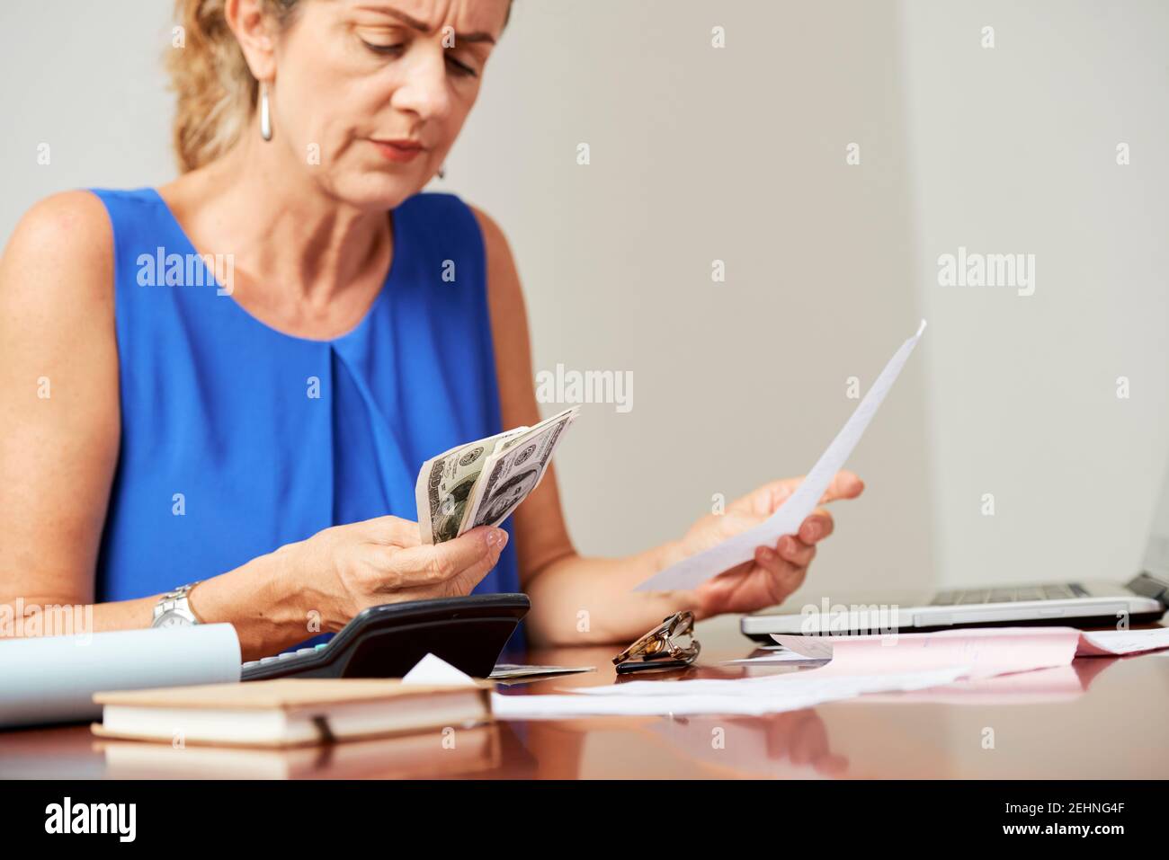 Stressed woman counting money Stock Photo - Alamy