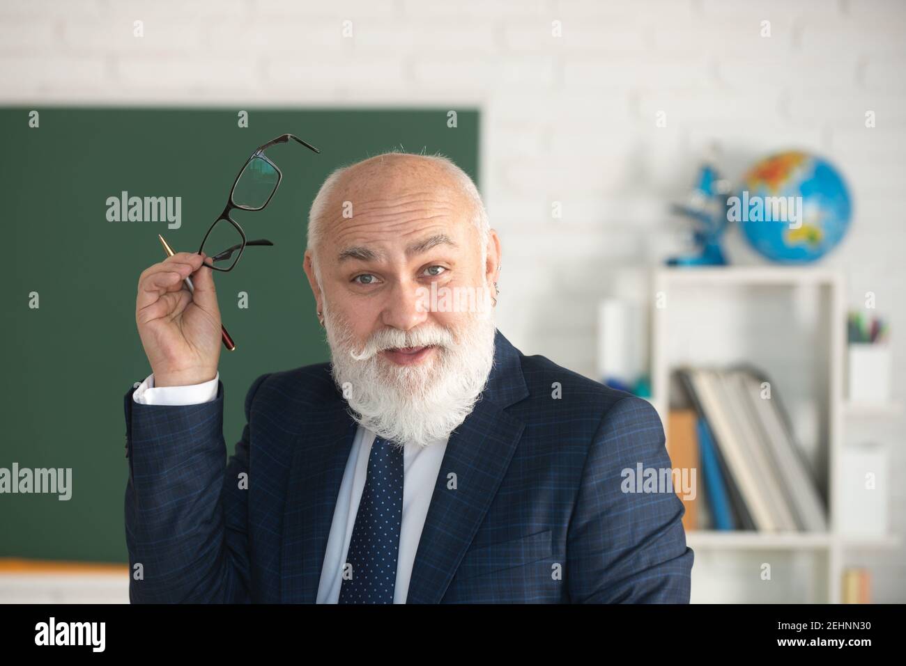 Funny professor at school. Teacher smiling in classroom Stock Photo - Alamy