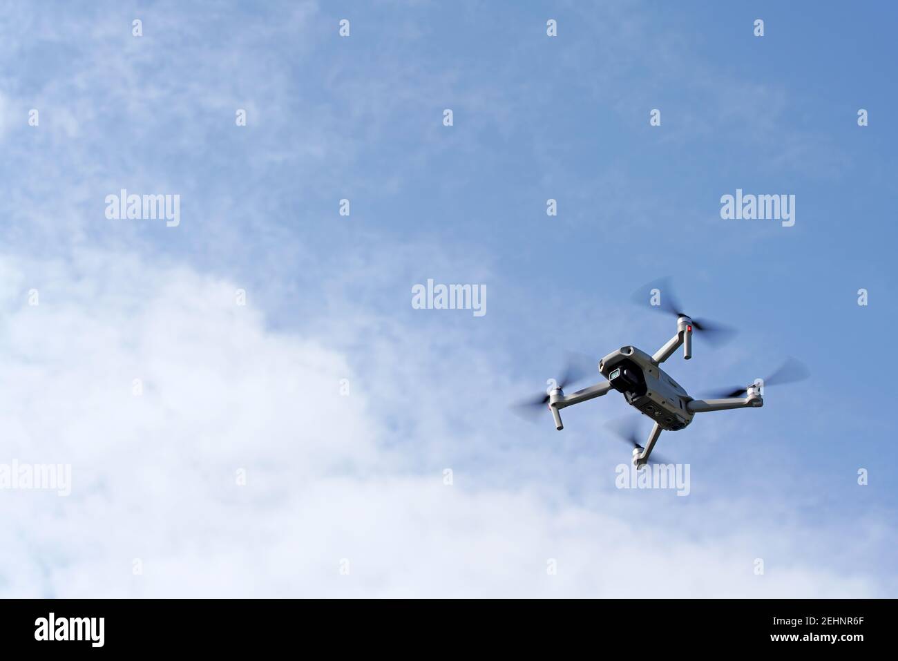 drone flying in air, blue sky with white clouds Stock Photo - Alamy