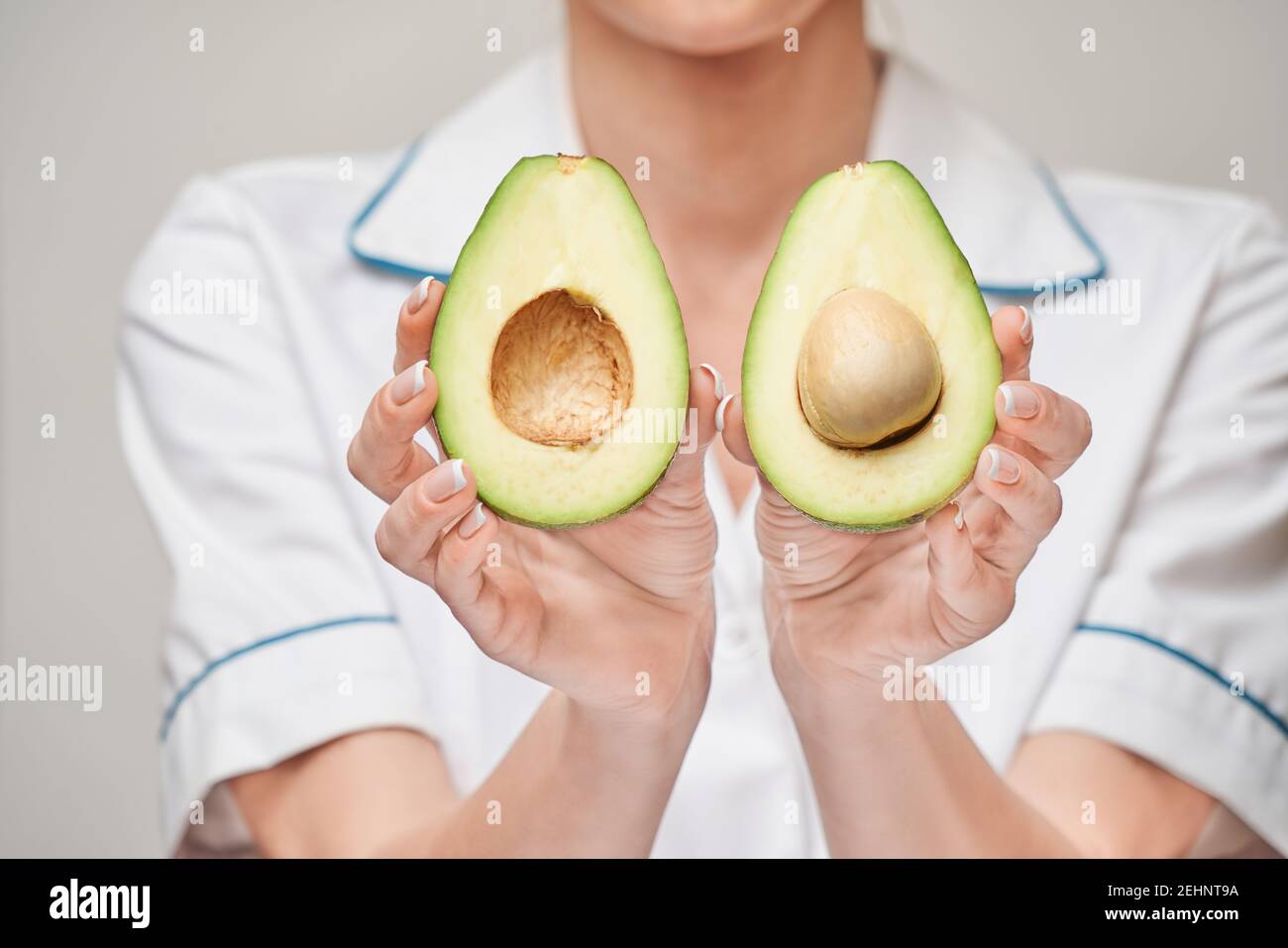 nutritionist doctor healthy lifestyle concept - holding organic avocado ...