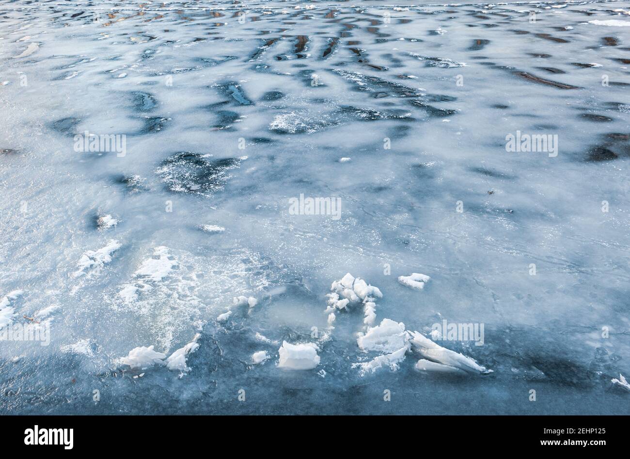 Frozen icy water background with snow Stock Photo - Alamy
