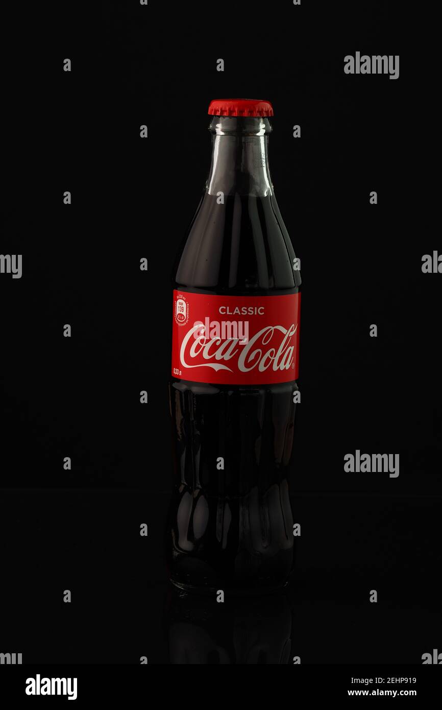 Coca-Cola. A classic glass bottle of Coca-Cola with a red lid ...