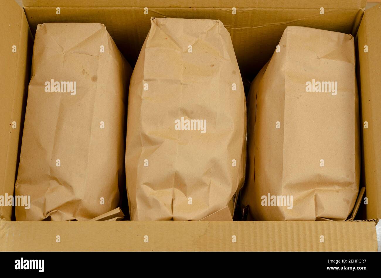 Ecological packaging and tare concept. Open cardboard box with packaged ...