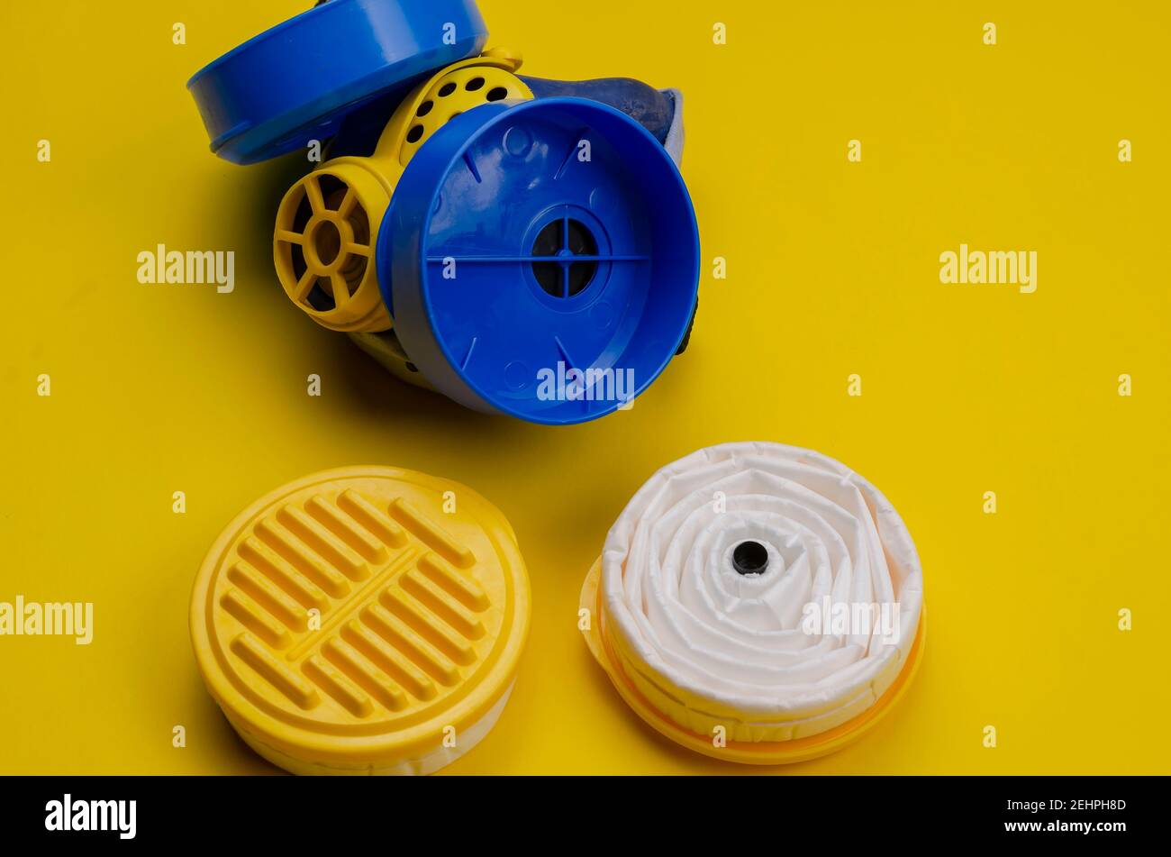 Industrial respirator with replaceable filters on yellow background ...