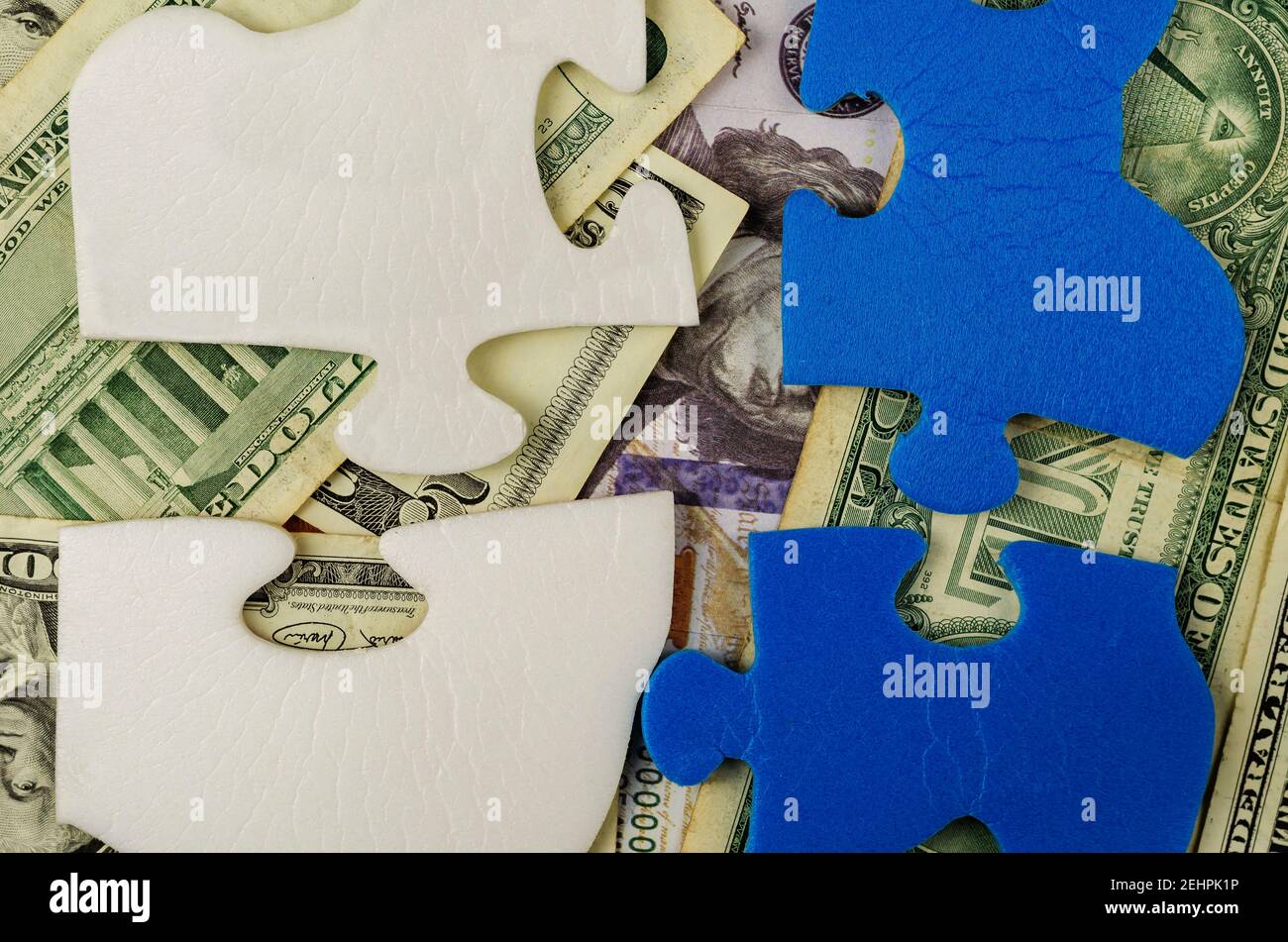American dollars of different denominations are hidden under the puzzle ...