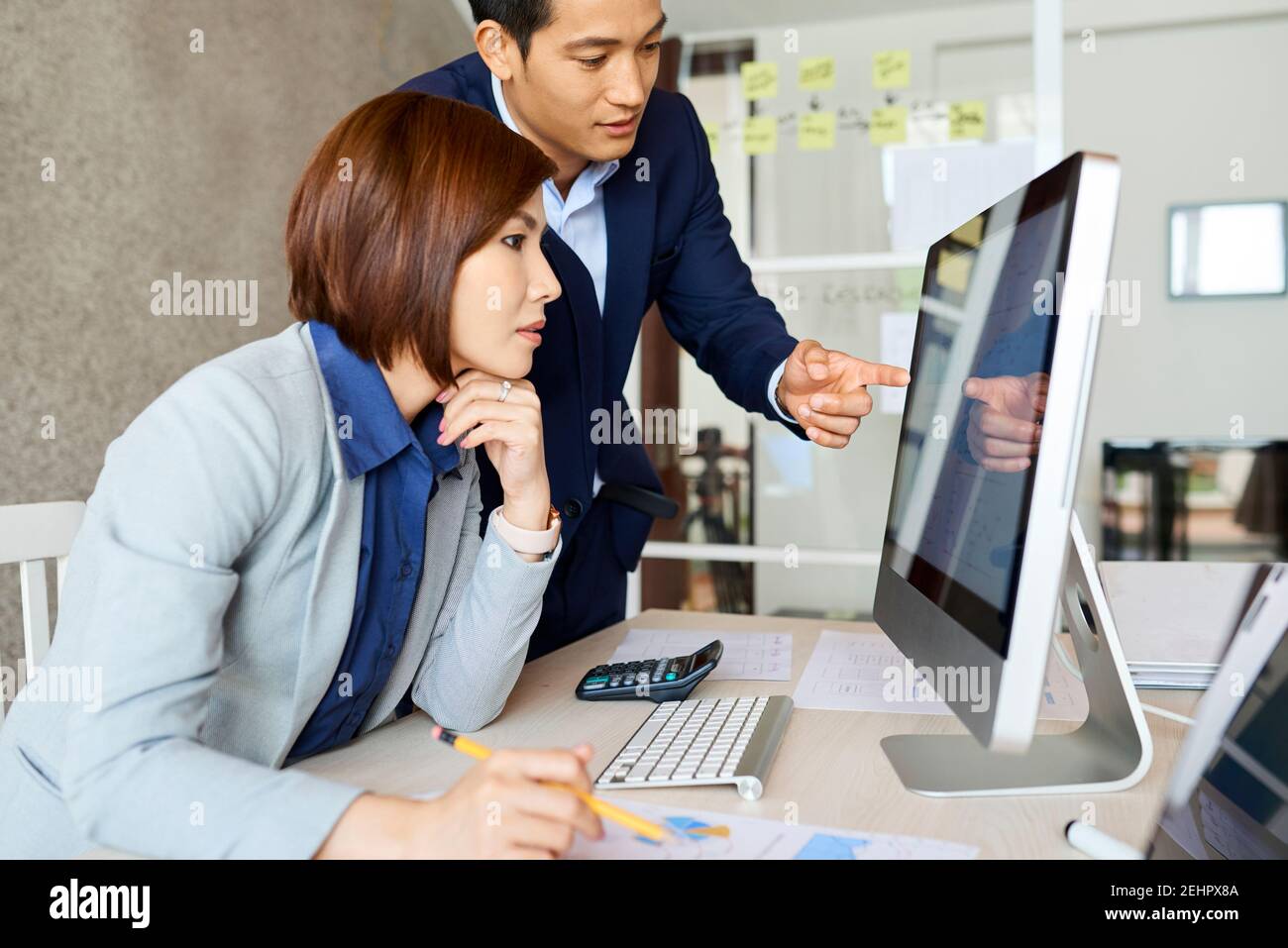 Business people discussing report Stock Photo - Alamy