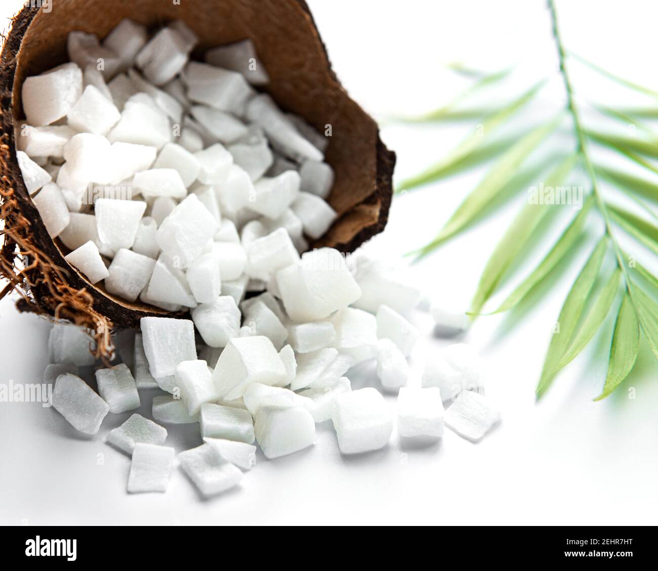 Dried sweet coconut cubes in bowl on white background Stock Photo - Alamy