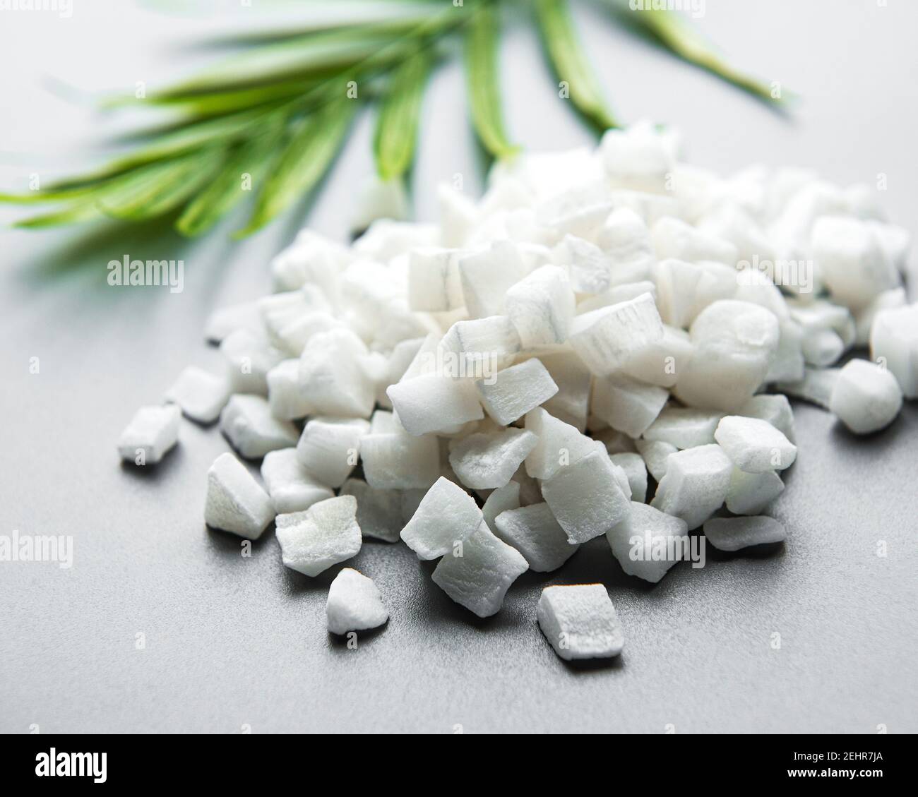 Dried sweet coconut cubes on a white background Stock Photo - Alamy