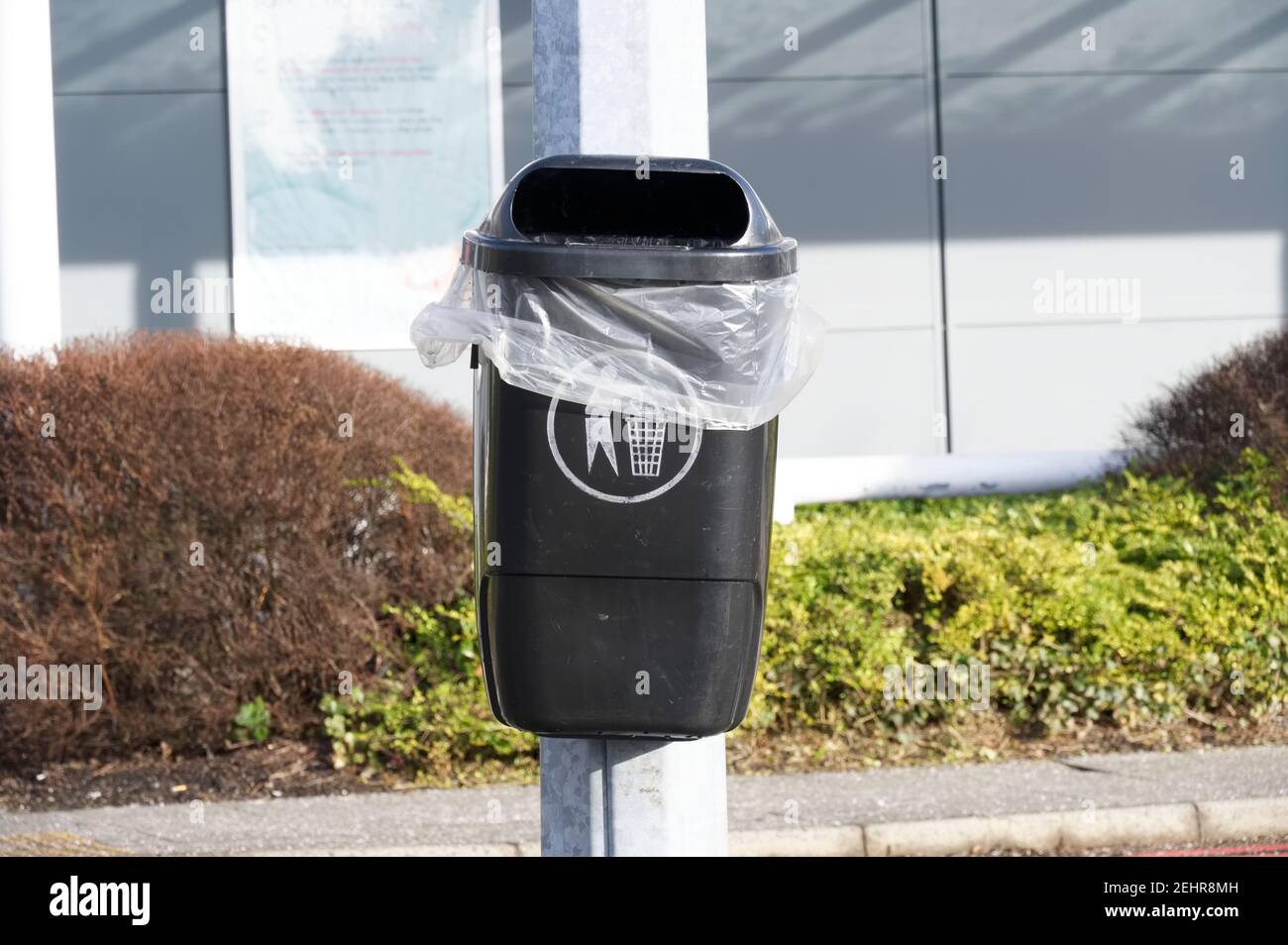 Black litter bin for rubbish in public area Stock Photo - Alamy
