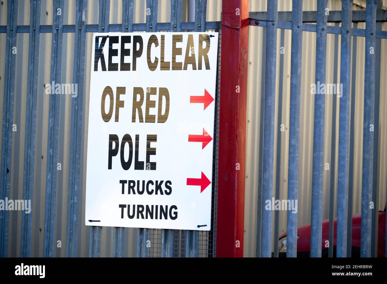 Keep clear trucks turning sign on fence Stock Photo - Alamy