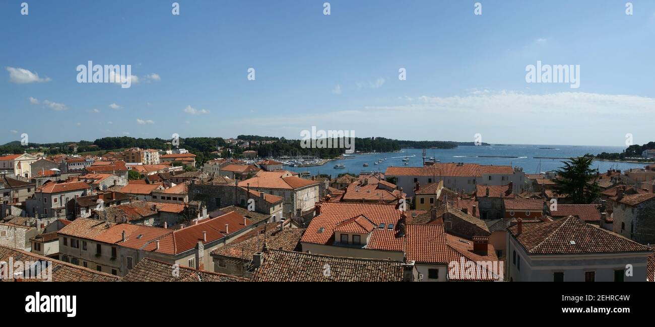 Panoramic landscape with the sky, the sea and rooftops, Porec, Croatia ...