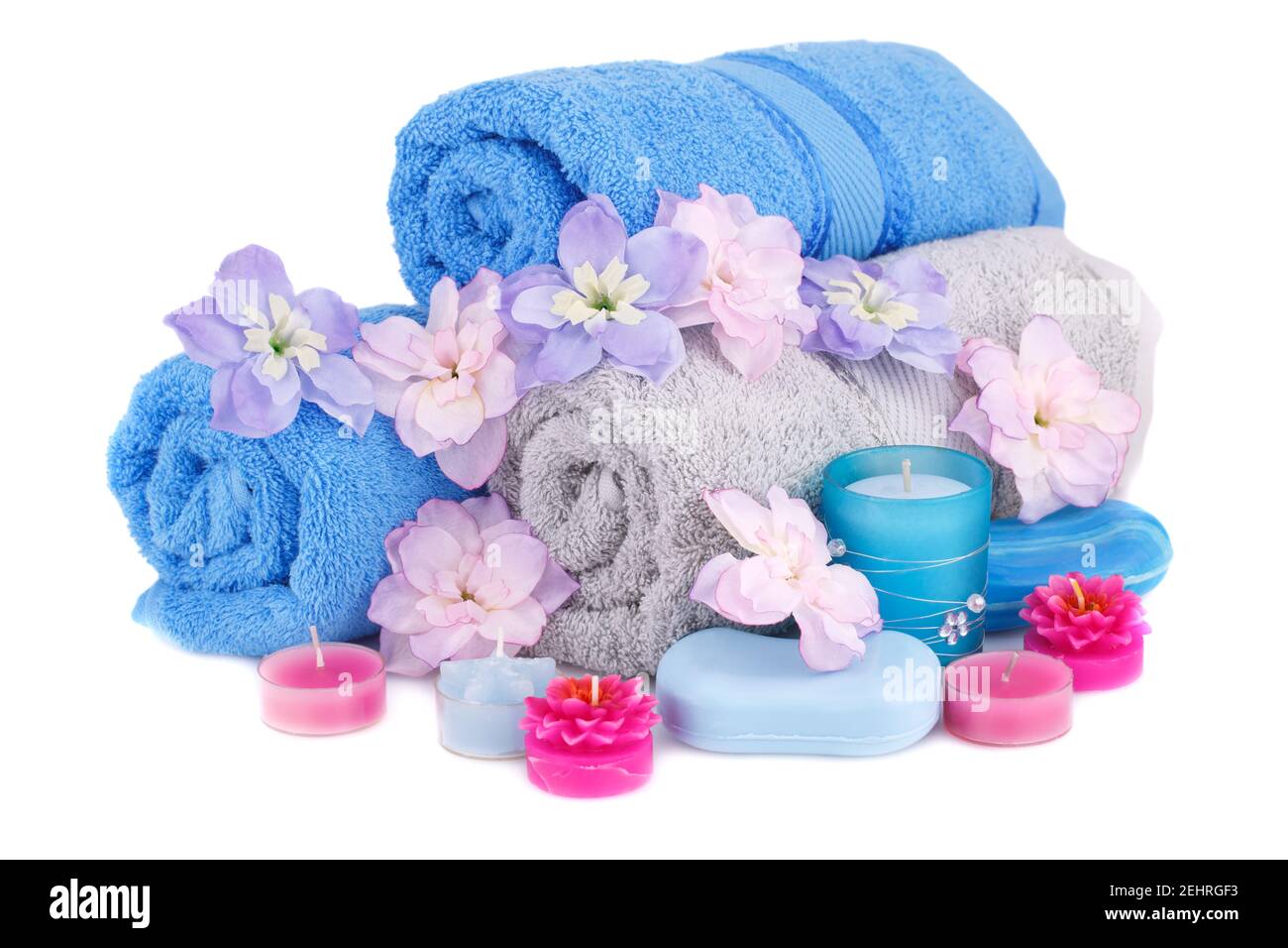 Spa set with towels, candles, soaps and flowers isolated on white ...
