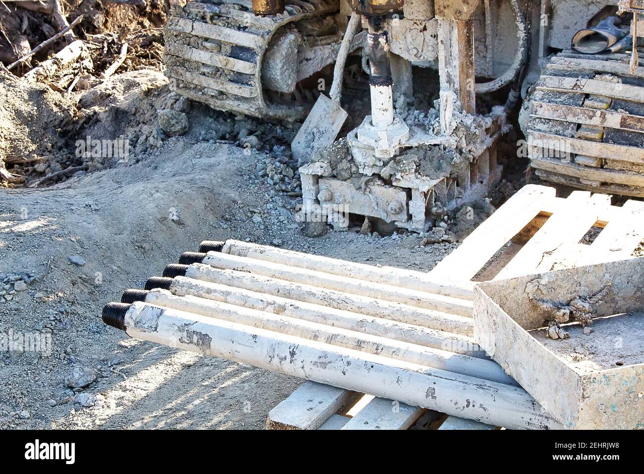Mini-drilling rig on crawler track on site of sawn forest where large ...