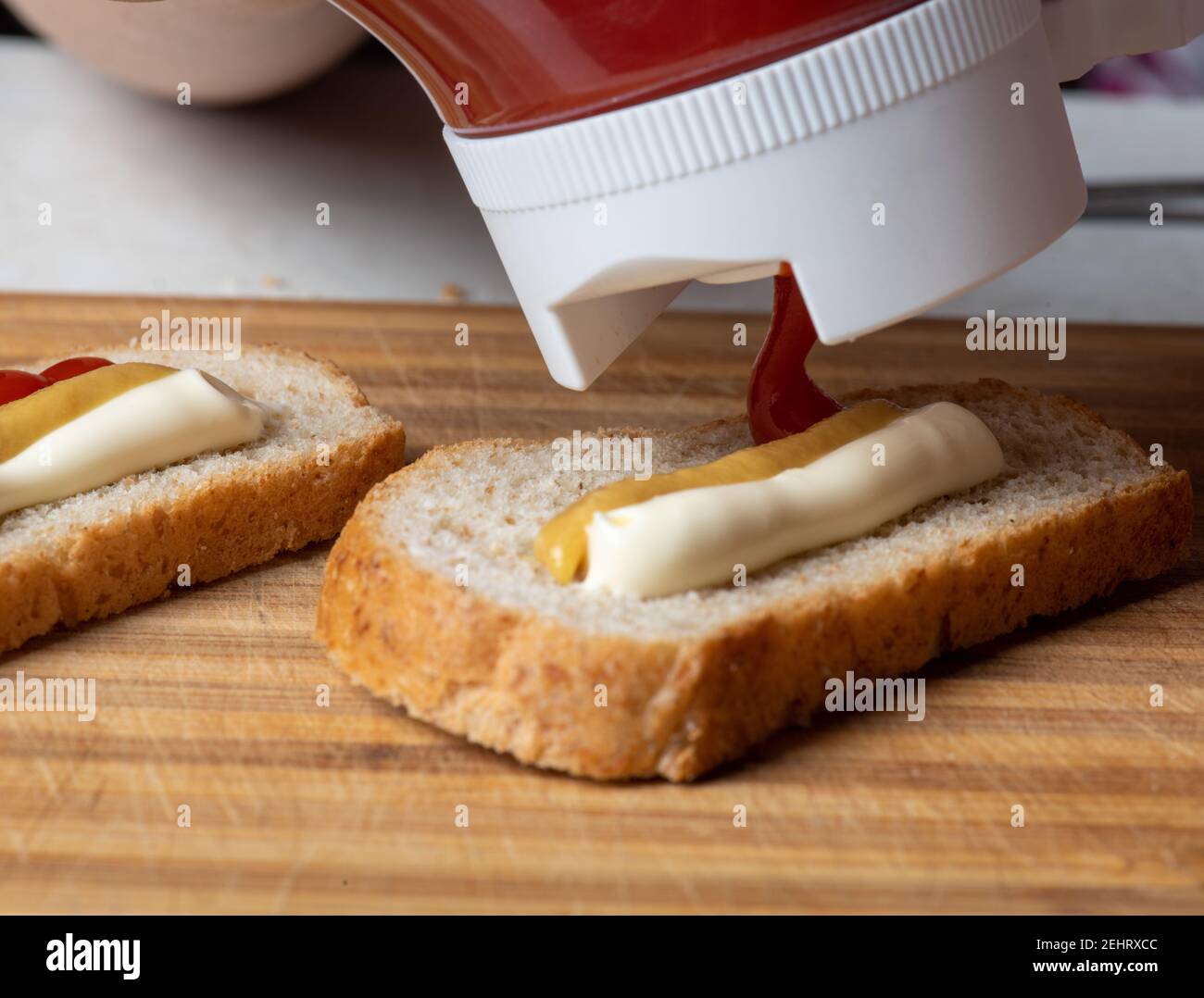 A piece of cake sitting on top of a wooden cutting board Stock Photo ...