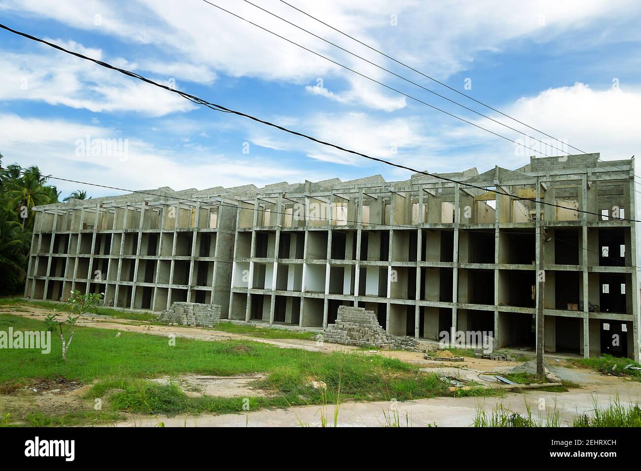Construction of a factory in a tropical Asian country surrounded by ...
