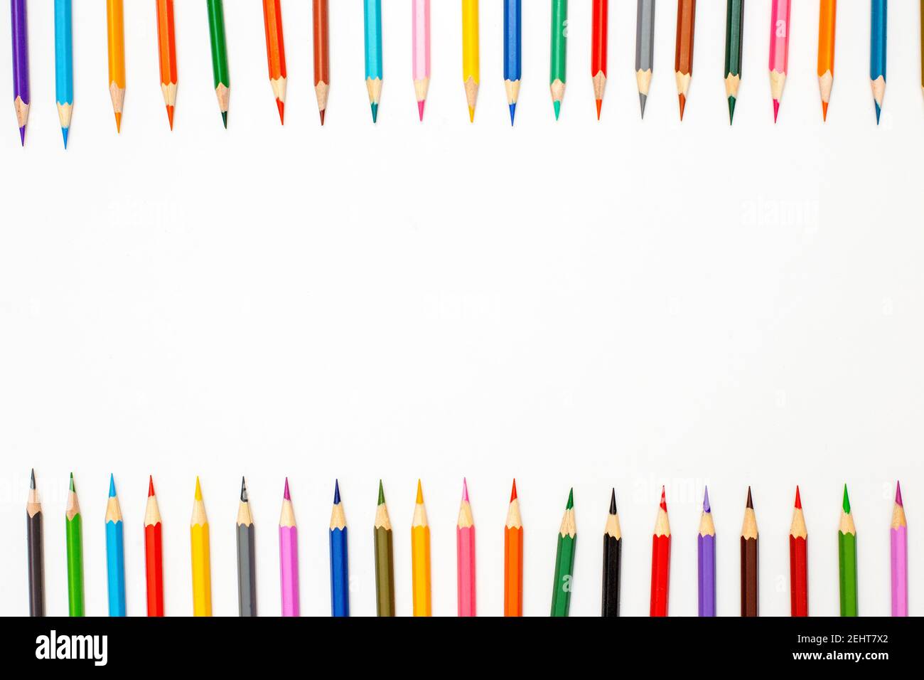 frame from multicolor pencils in a row with the top on a white ...