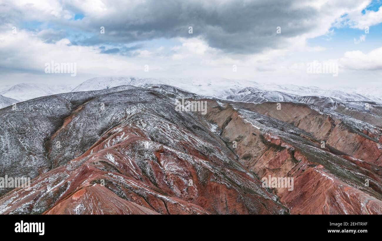 Peaks of the red mountains are covered with snow, winter highlands ...