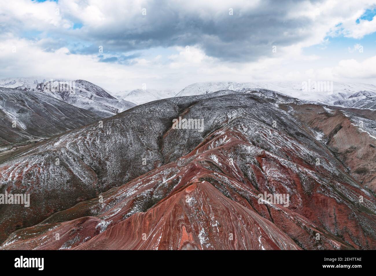 Peaks of the red mountains are covered with snow, winter highlands ...