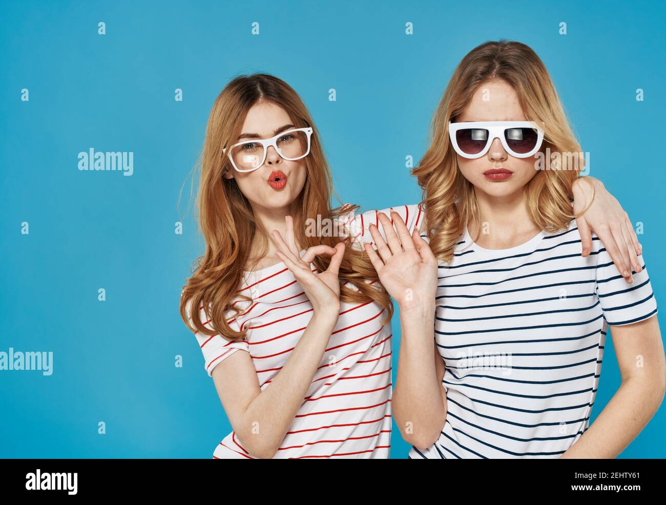 two pretty women gesticulate with hands fun friendship joy lifestyle ...