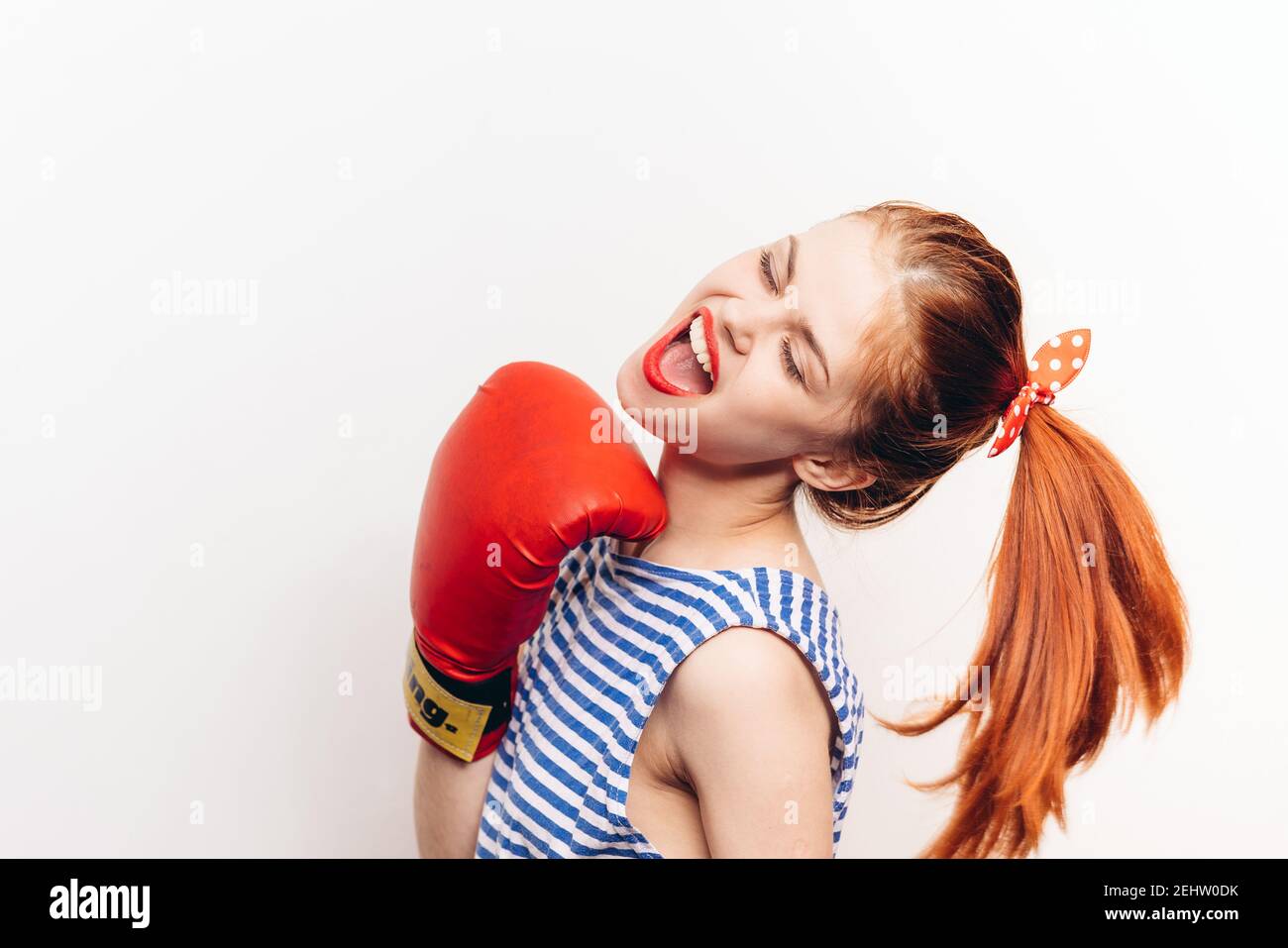aggressive woman are engaged in boxing on a light background in a ...