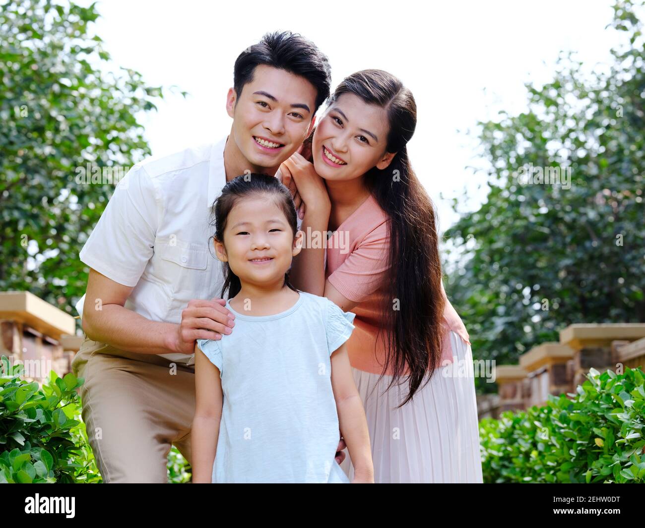 Happy family of three in the outdoor smiling Stock Photo - Alamy