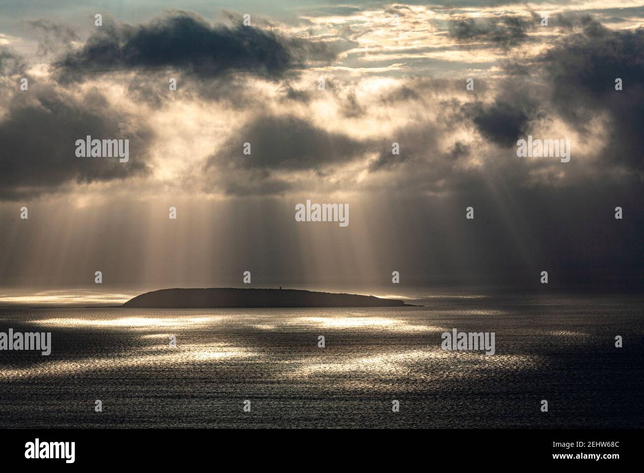Puffin Island, Anglesey, North Wales with clouds and sunbeams Stock ...